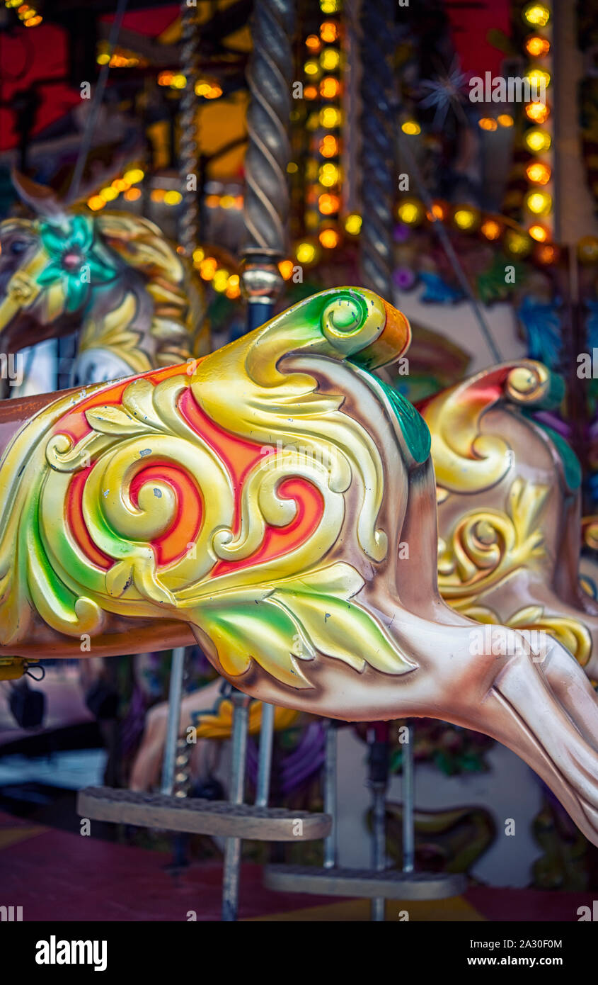 Colourful carousel horses at a fairground Stock Photo - Alamy