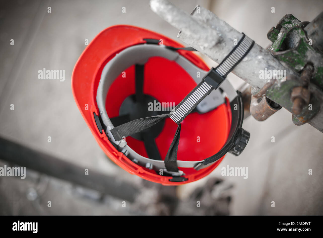 Safety helmet in construction site with scaffolding and working tools ...