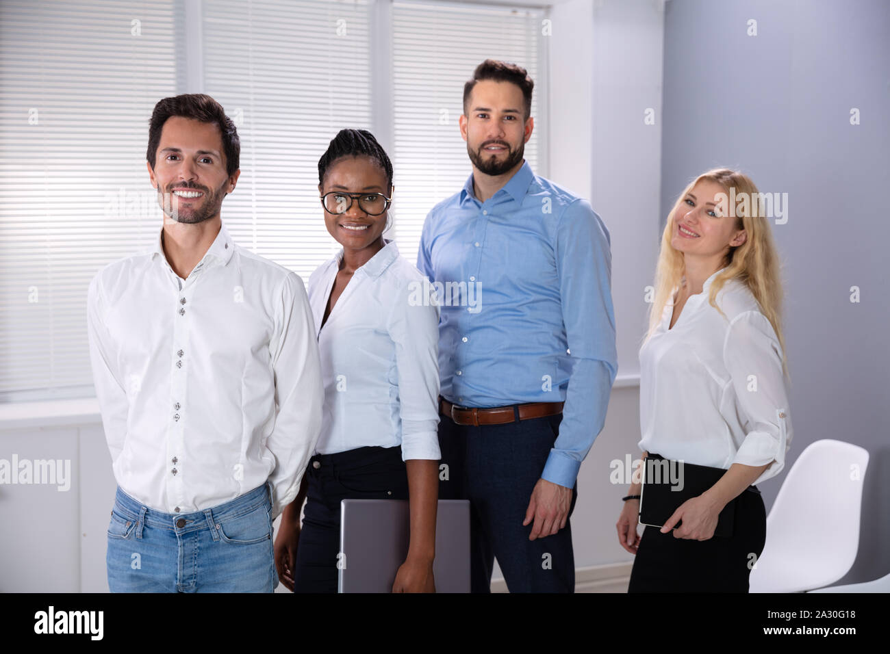 Successful group of business people at the office looking at the camera ...