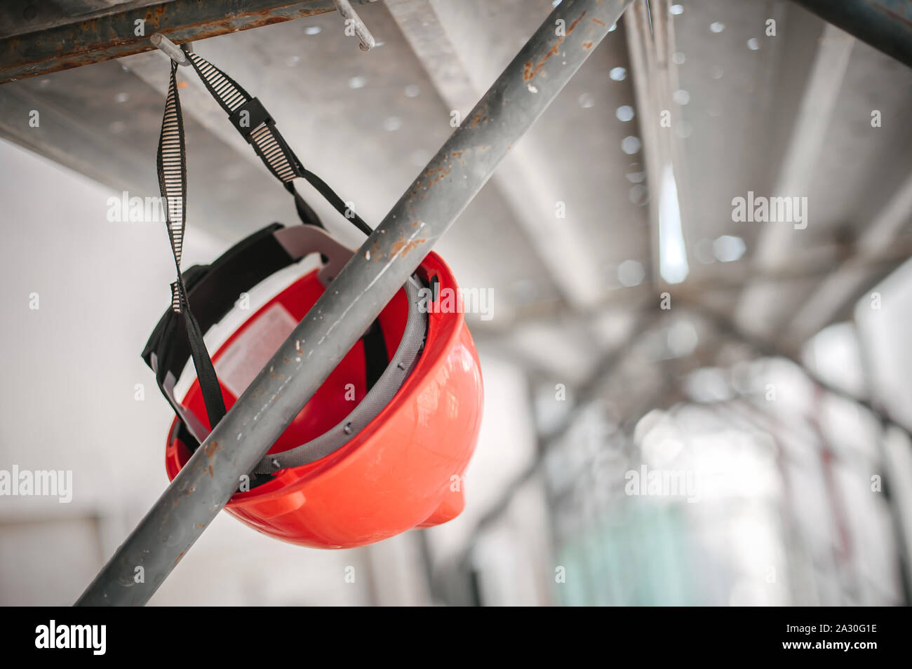 Safety helmet in construction site with scaffolding and working tools ...