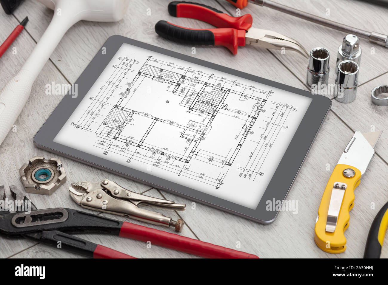 Tablet with construction tools and blueprint concept Stock Photo - Alamy