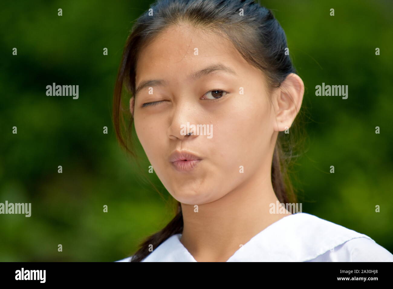 An An Asian Girl Winking Stock Photo - Alamy