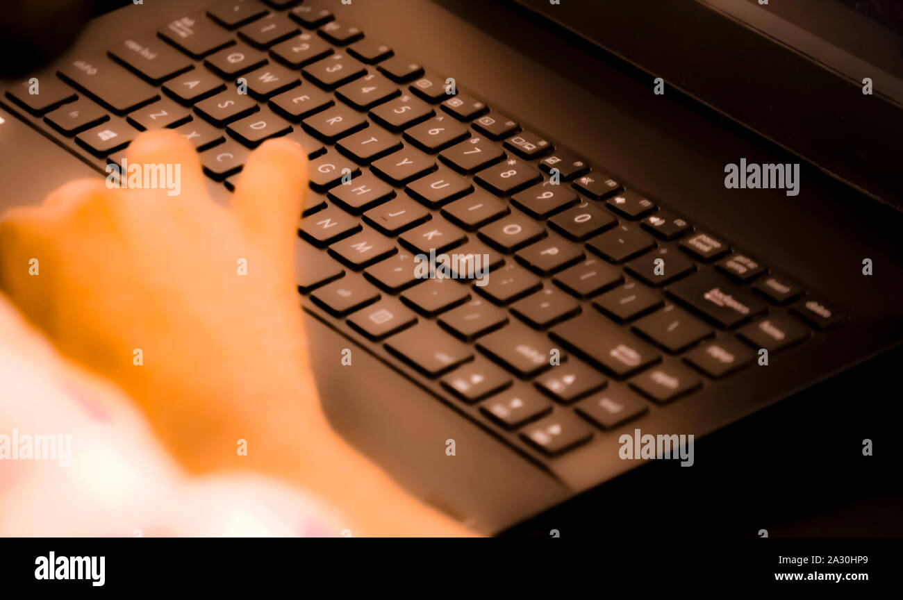 A is busy for typing with his laptop Stock Photo - Alamy