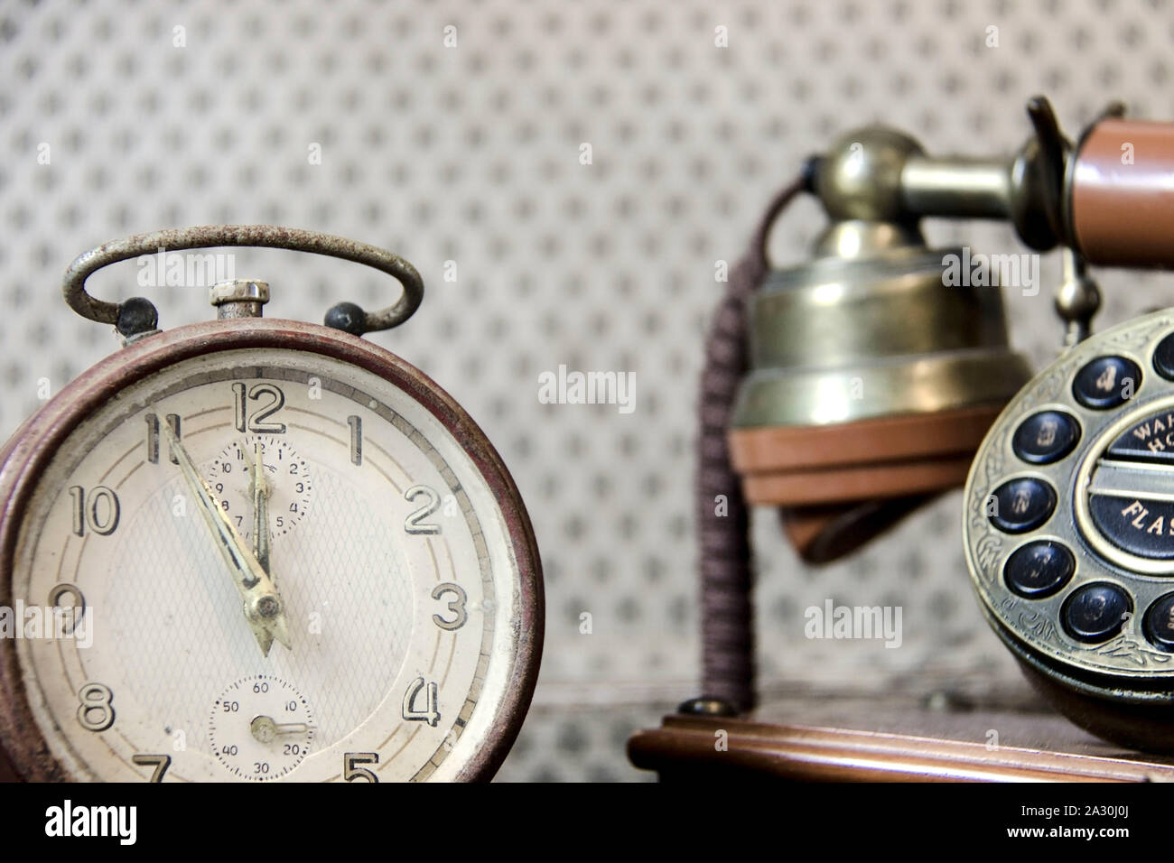 Vintage alarm clock and old telephone Stock Photo - Alamy
