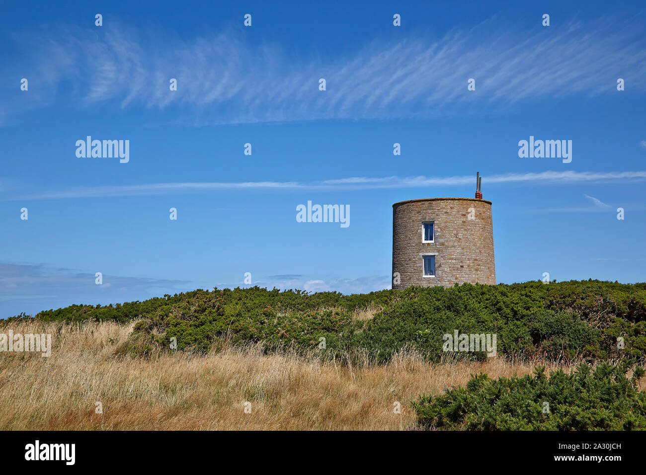 Landscape with a house converted from a round stone tower, originally a ...