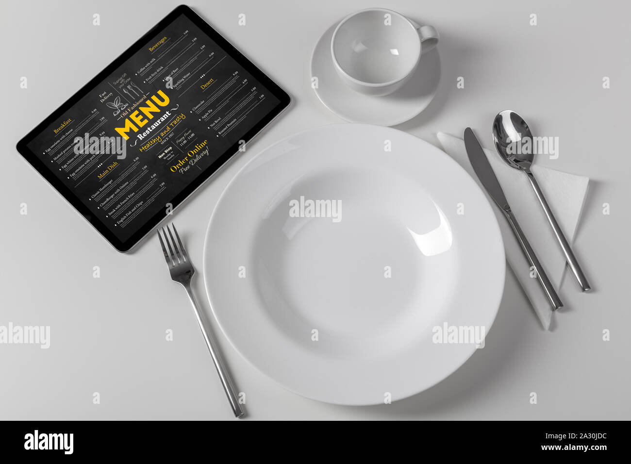 Empty plate and tableware with online order menu Stock Photo - Alamy