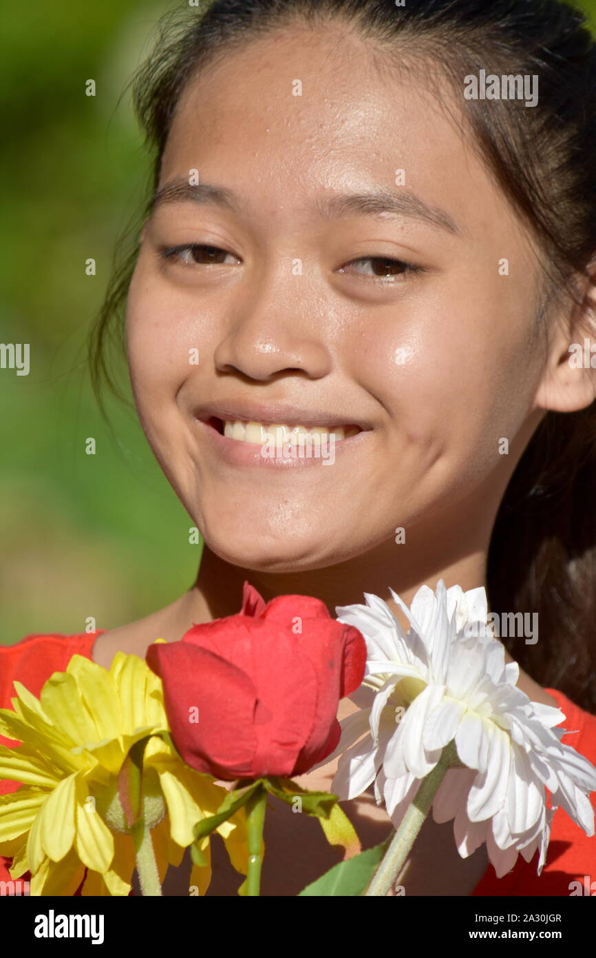 Minority Teen Girl Smiling With Flowers Stock Photo - Alamy