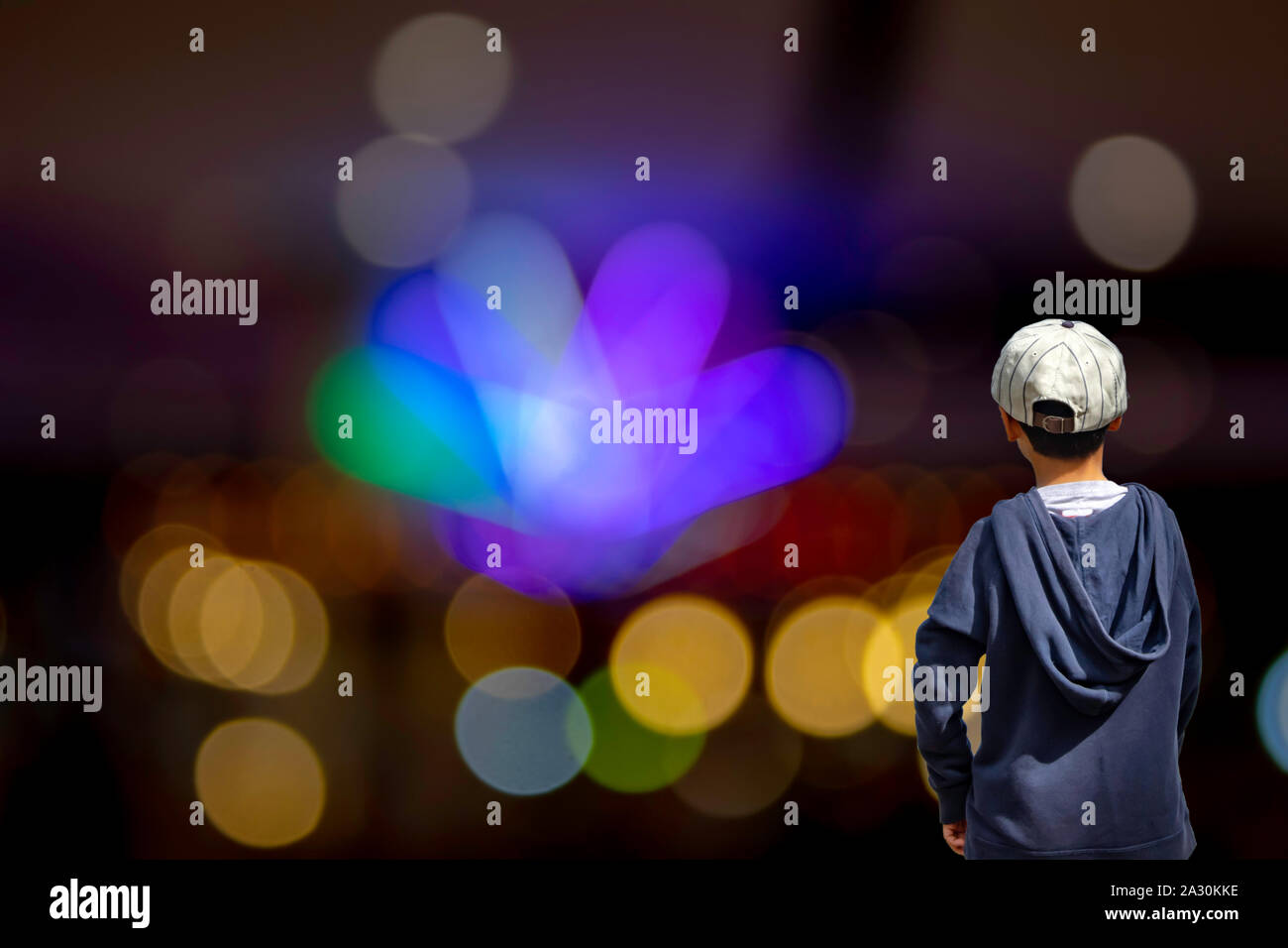 Asian boy see blurred lights of the house and street light, bright ...