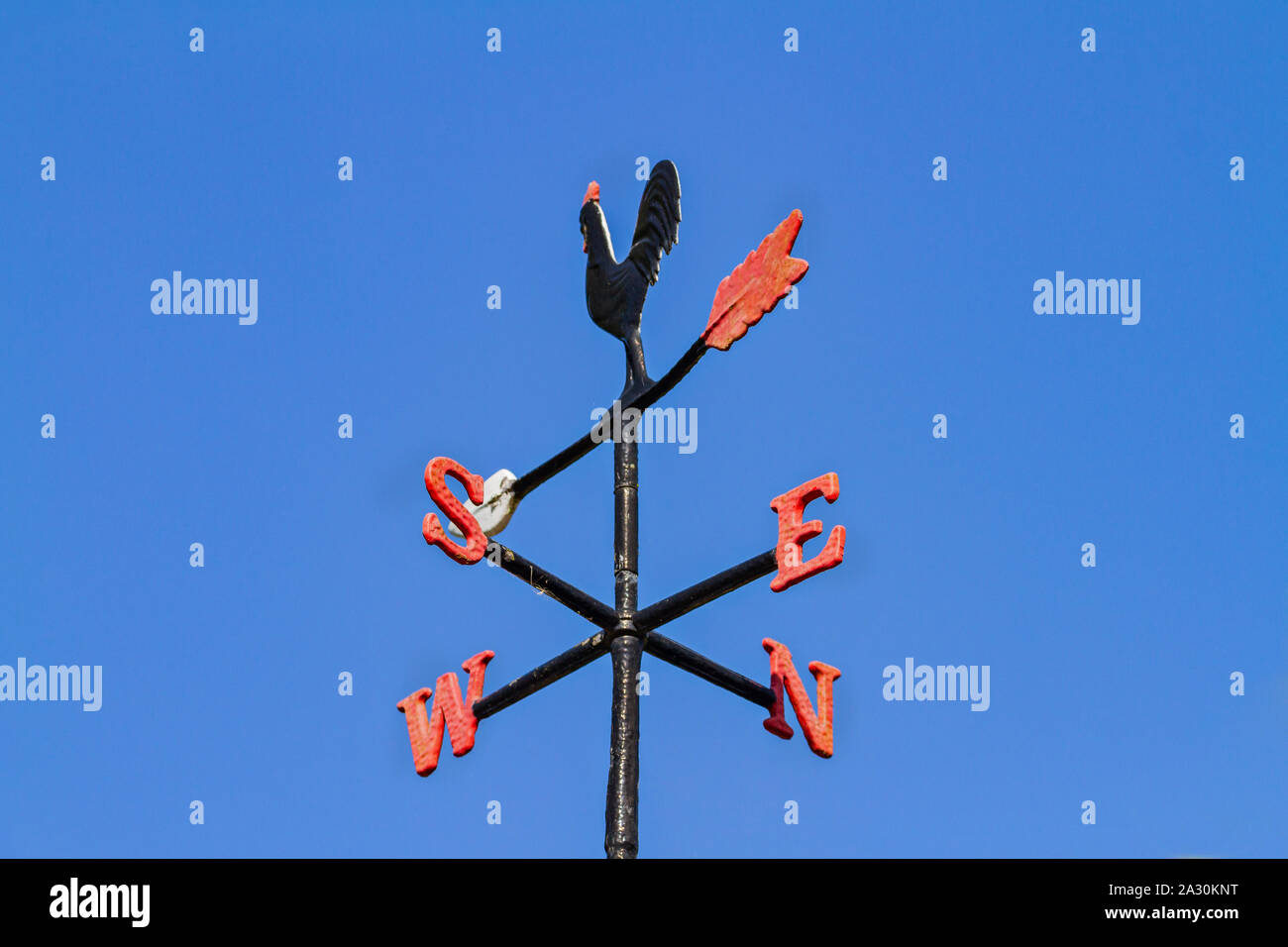 Cockerel Rooster weather vane, wind vane, weathercock against blue sky ...