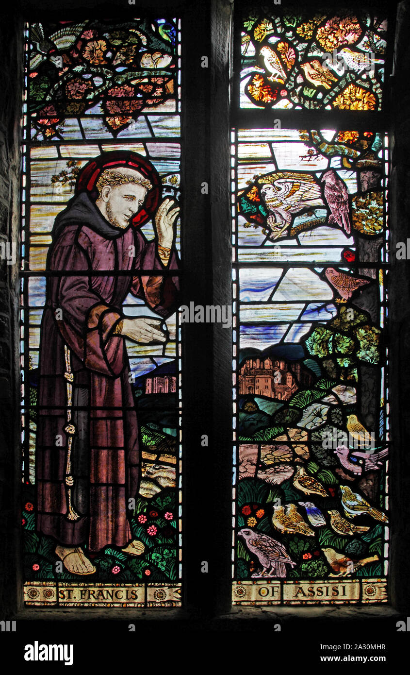 A stained glass window depicting St Francis of Assisi, St Thomas a ...