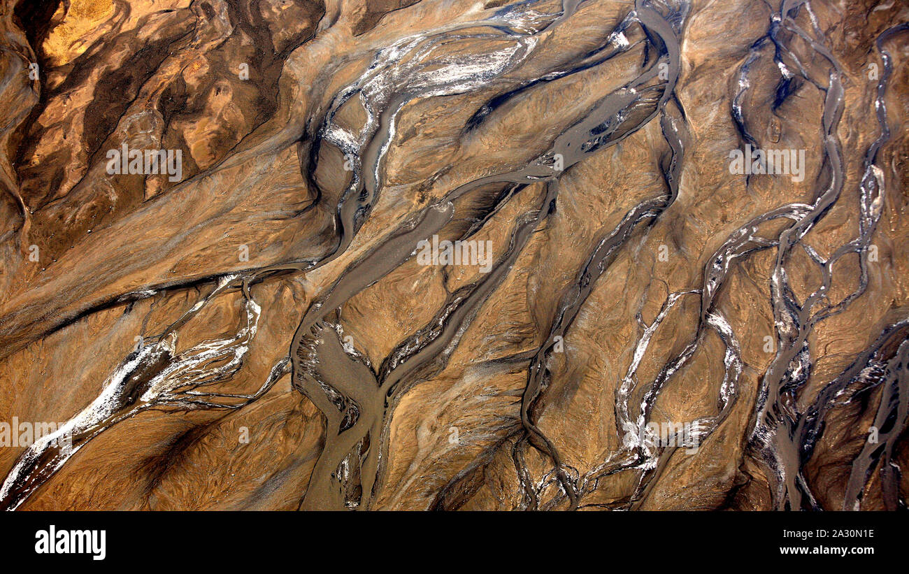 A torrent of water coming from the melting glacieron top of the ...