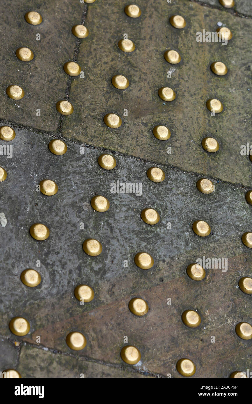 Brass studs in the pavement at a pedestrian crossing to help the ...