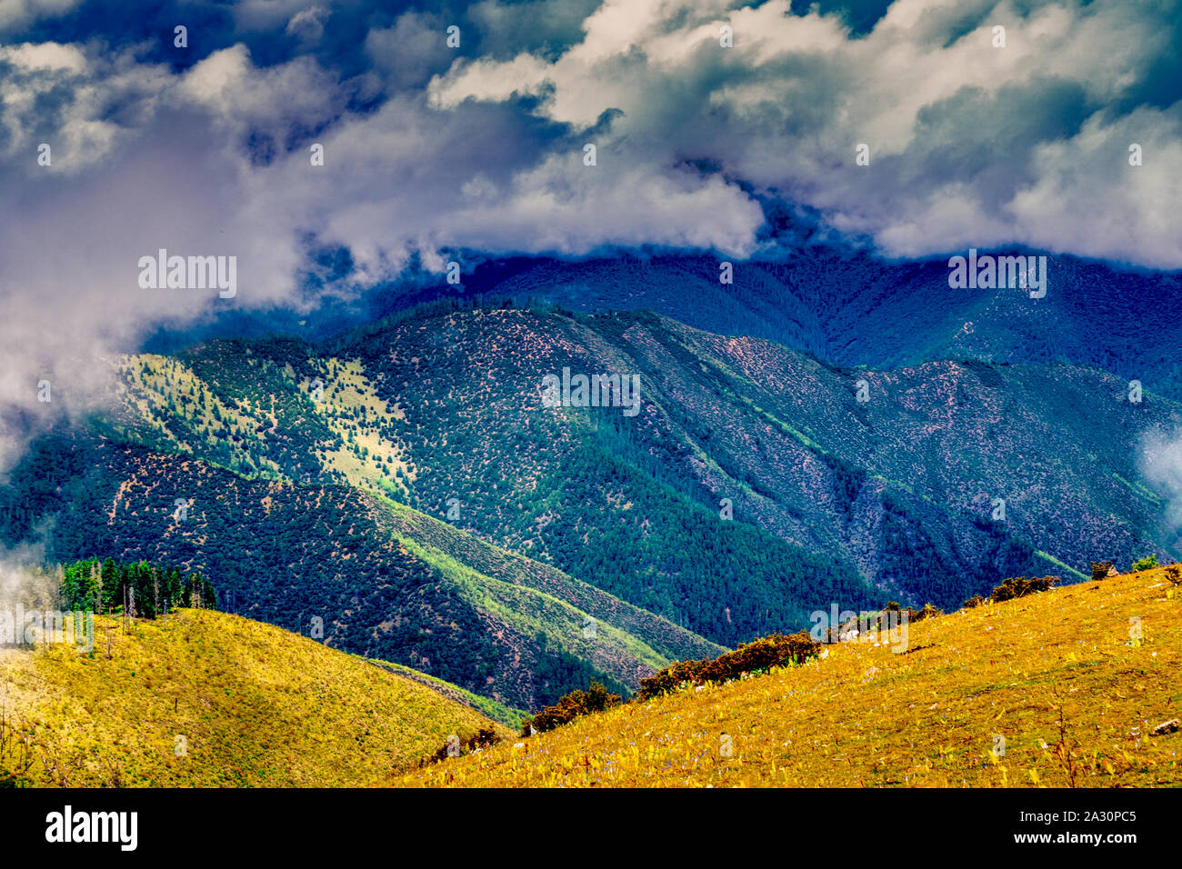 Mountains against dramatic clouds in the afternoon during autumn in ...