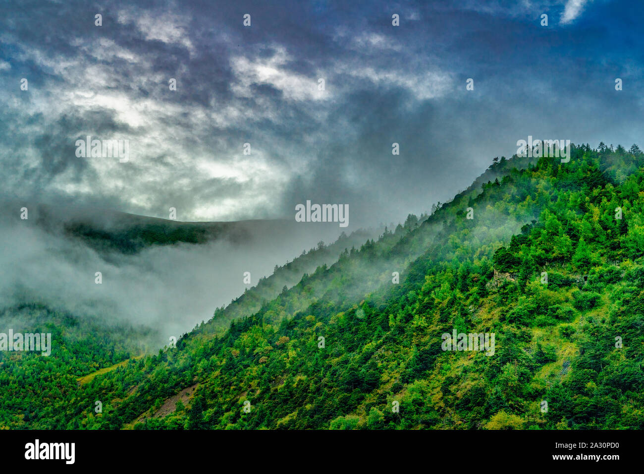 Mountains against dramatic clouds in the afternoon during autumn in ...