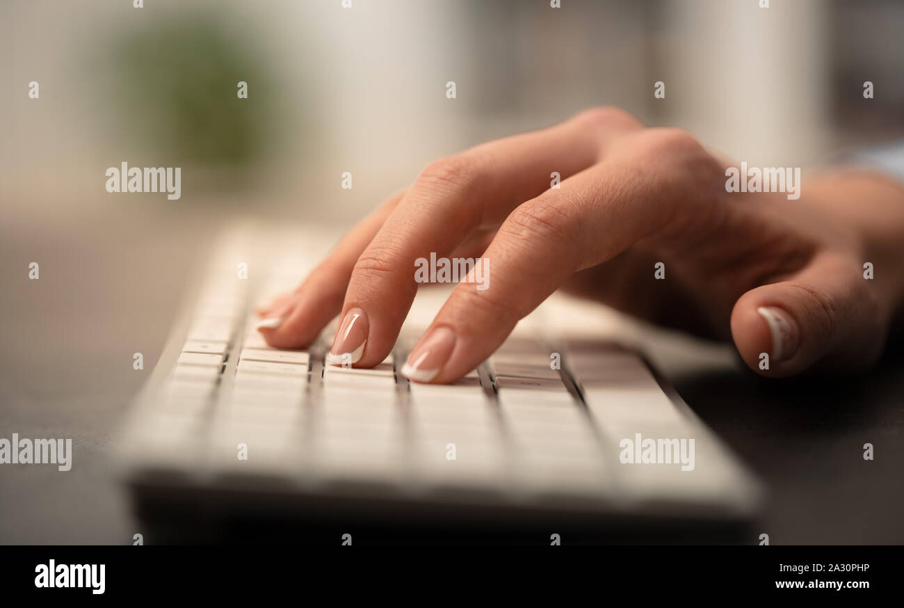 Hand typing on keyboard with office concept Stock Photo - Alamy