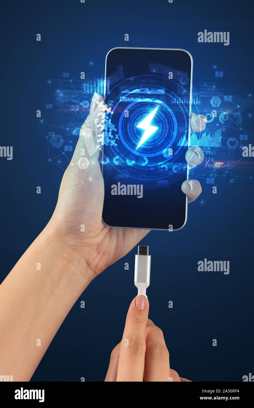 Elegant hand charging smartphone with global report concept Stock Photo ...