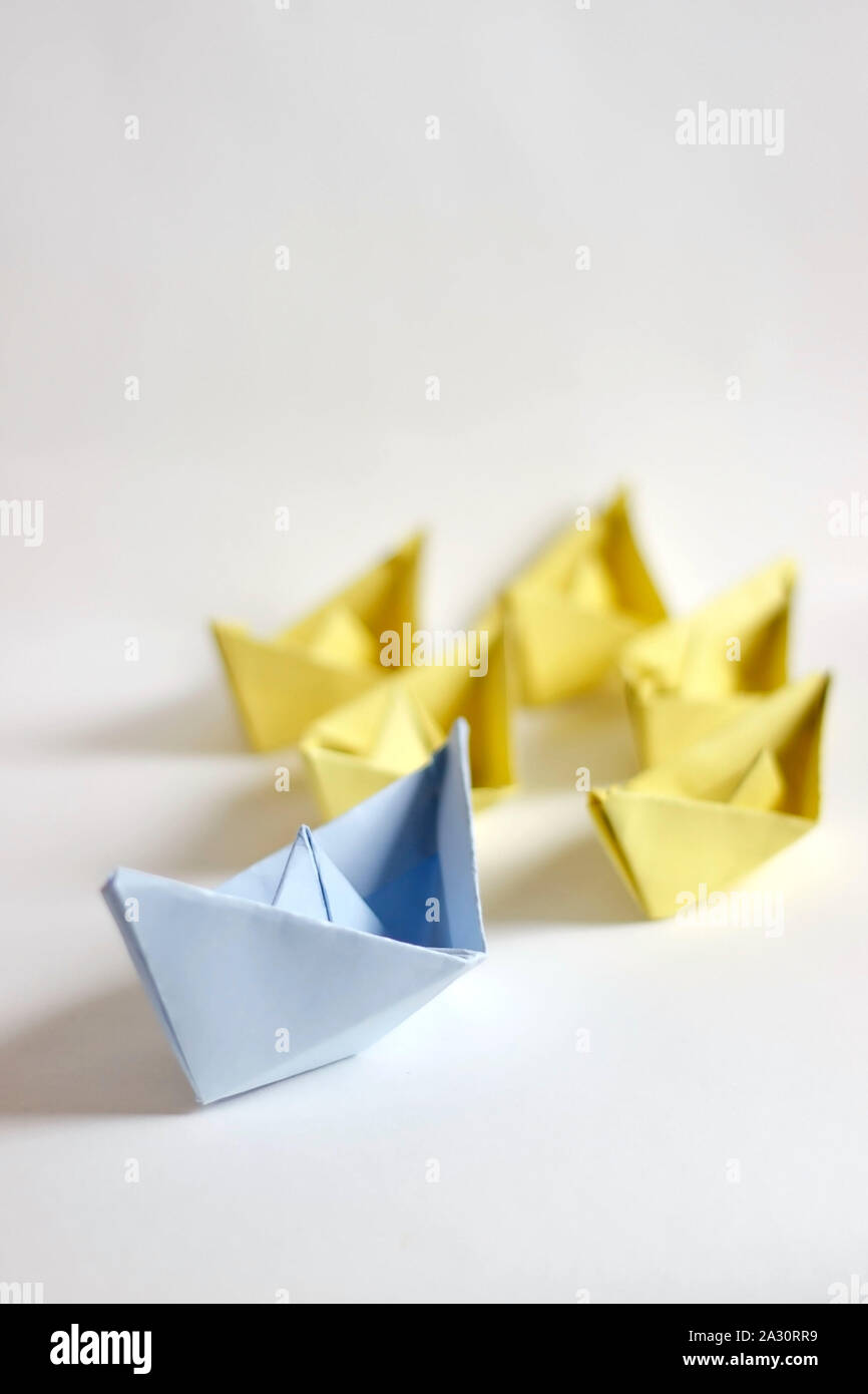 Leadership concept. Paper boats on a white background. Leader before ...