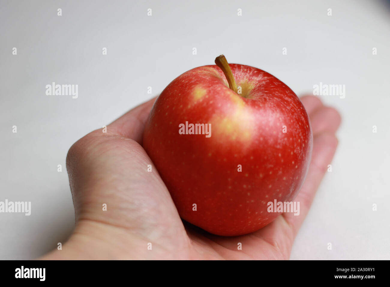 Apple in a hand hi-res stock photography and images - Alamy
