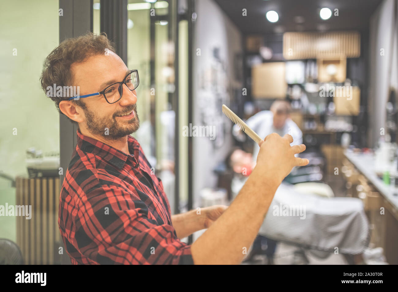 Man in front of barber shop waiting for the next client. Male haircut ...