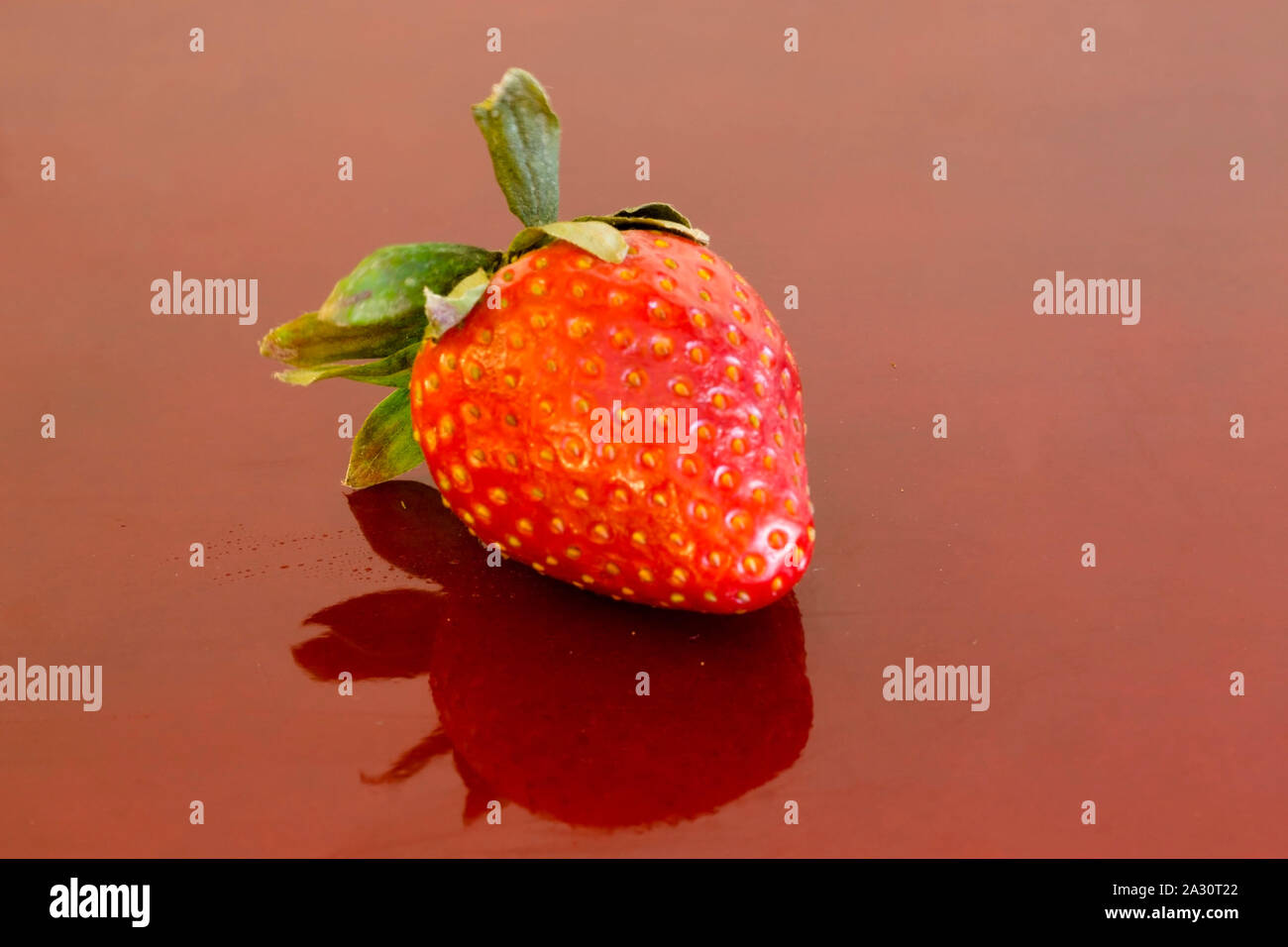 Strawberries on red background Stock Photo - Alamy