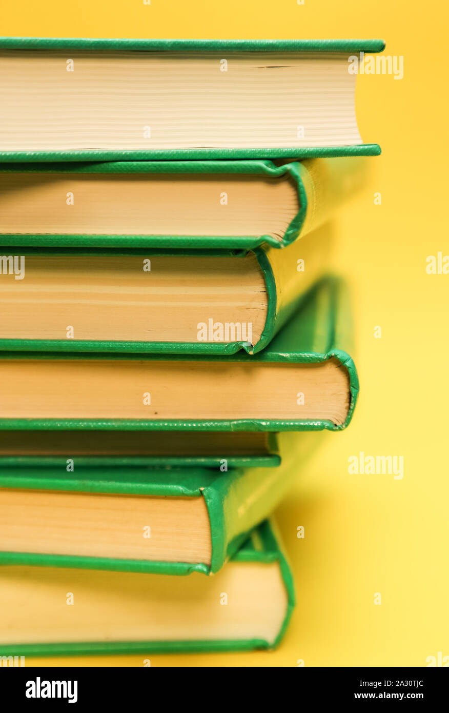 Book pile, over a yellow background - Education books background Stock ...