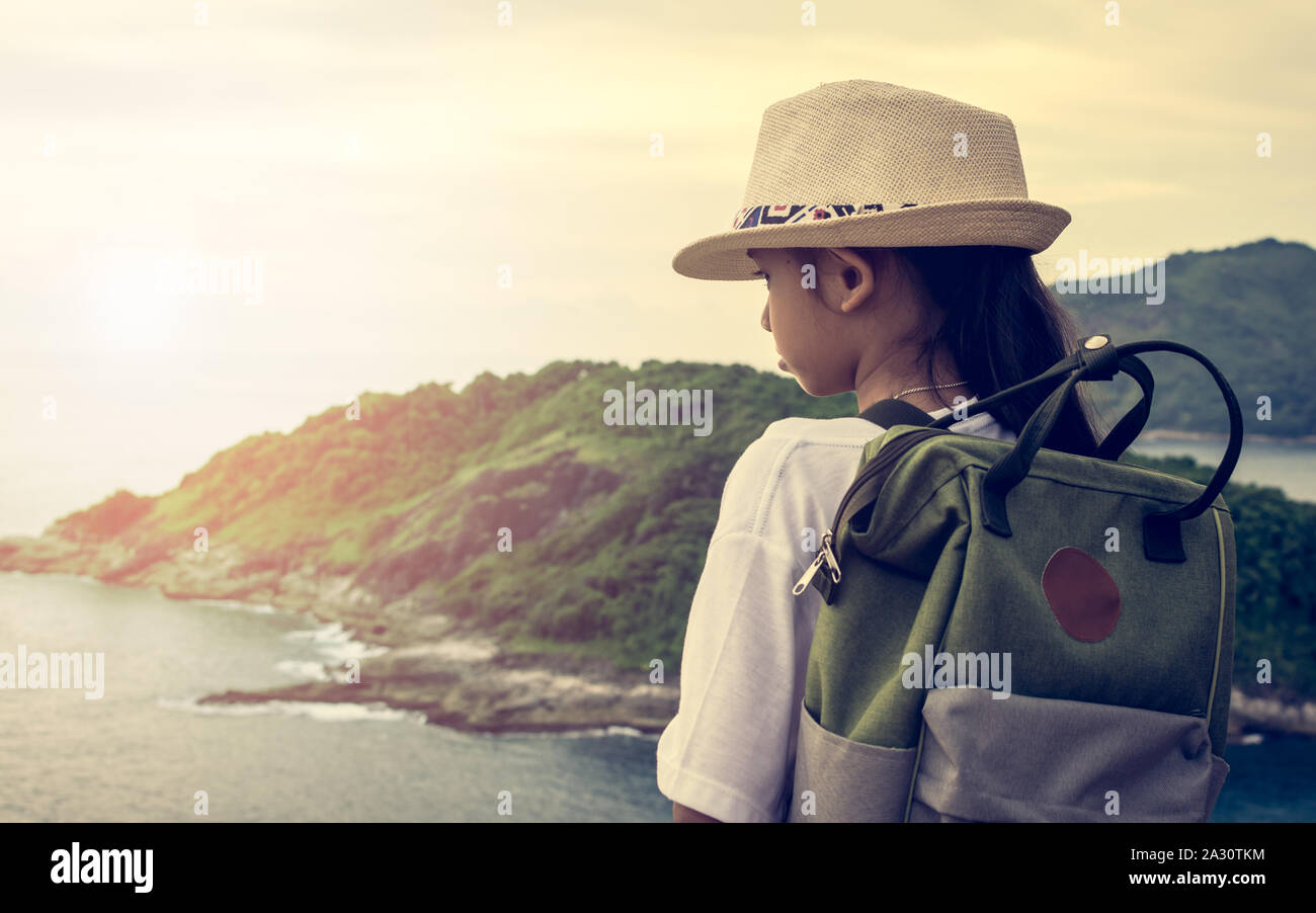 Cute girl with backpack viewing to the sea during sunset in phuket ...
