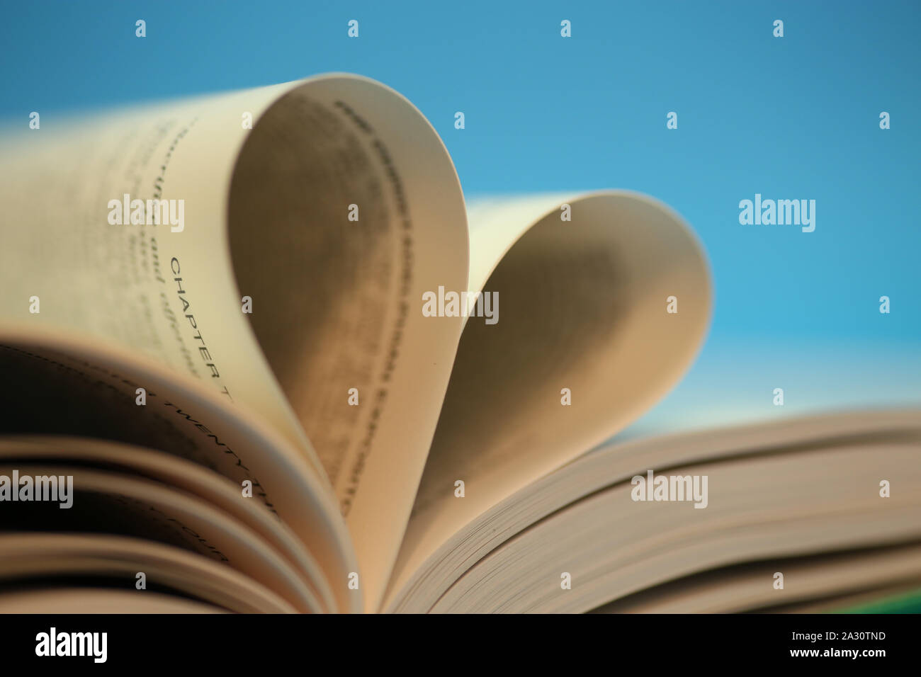 Heart shape book pages, over blue background Stock Photo - Alamy