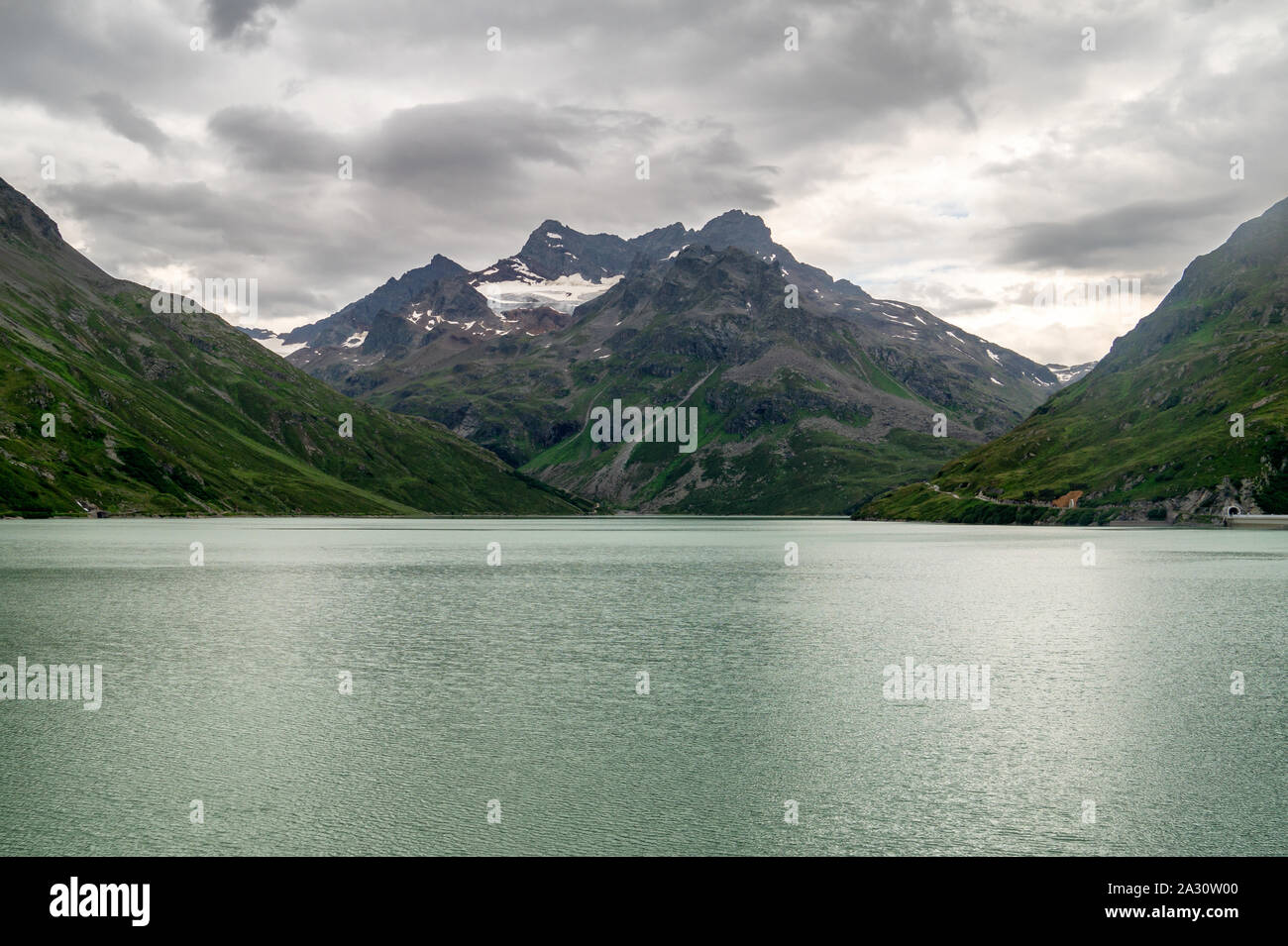 Picturesque lake Silvretta Stausee, mountain range and thunderclouds ...