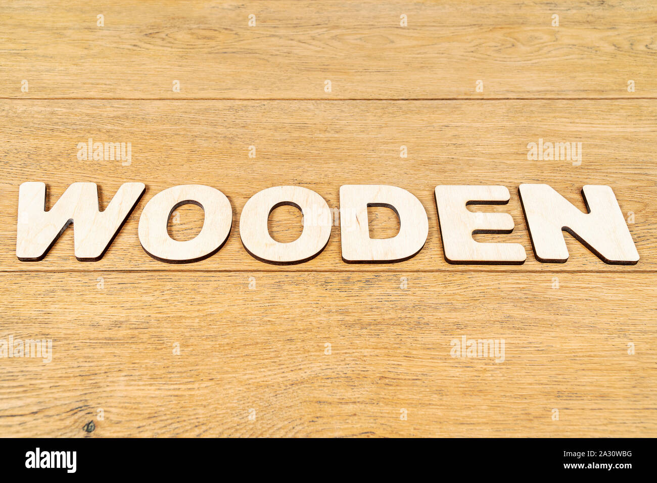 Word wooden on an old table Stock Photo - Alamy
