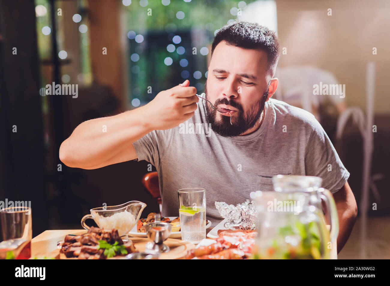 man at the big table with food Stock Photo - Alamy
