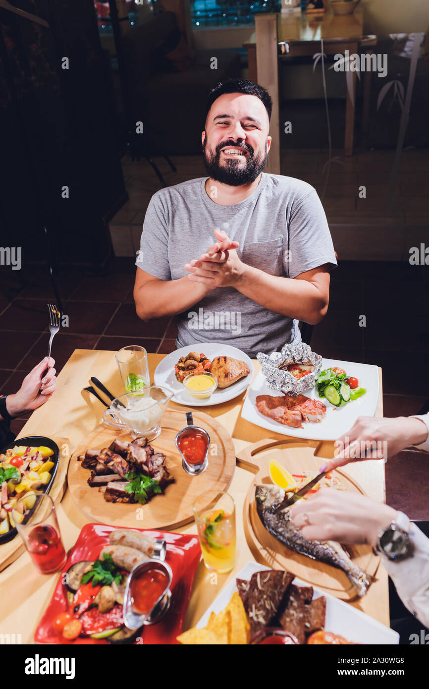 man at the big table with food Stock Photo - Alamy
