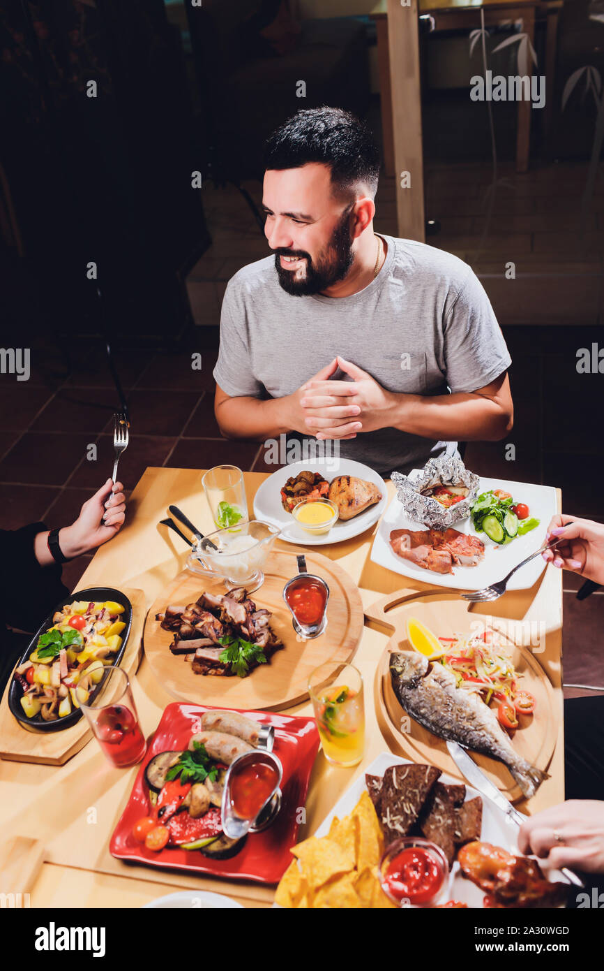 man at the big table with food Stock Photo - Alamy