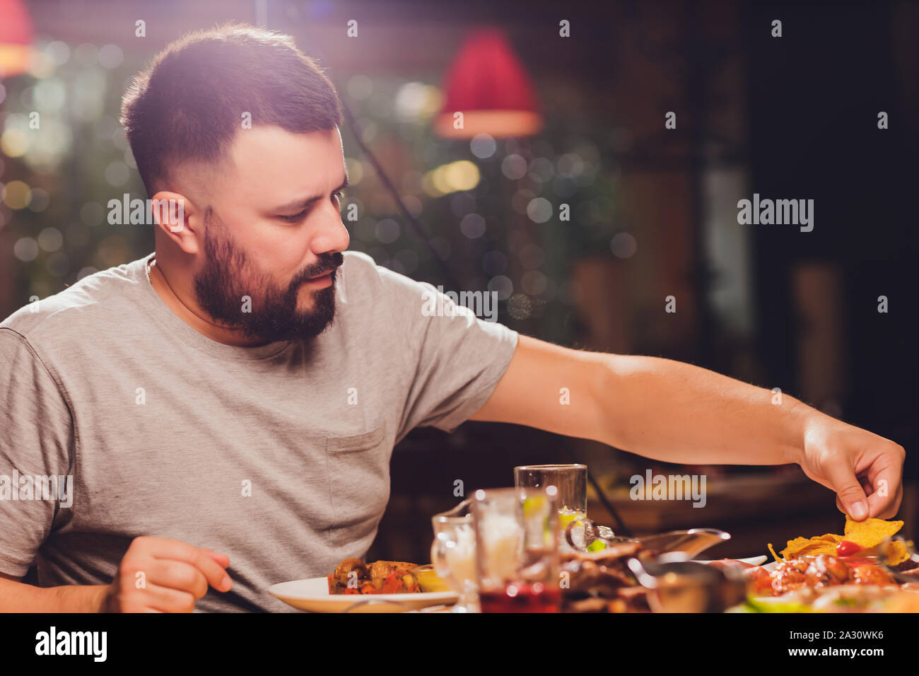 man at the big table with food Stock Photo - Alamy