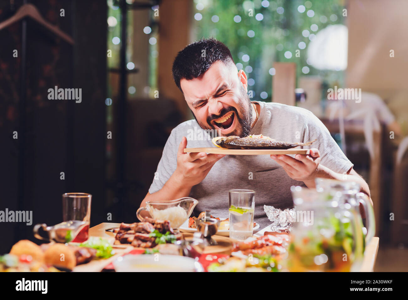 man at the big table with food Stock Photo - Alamy