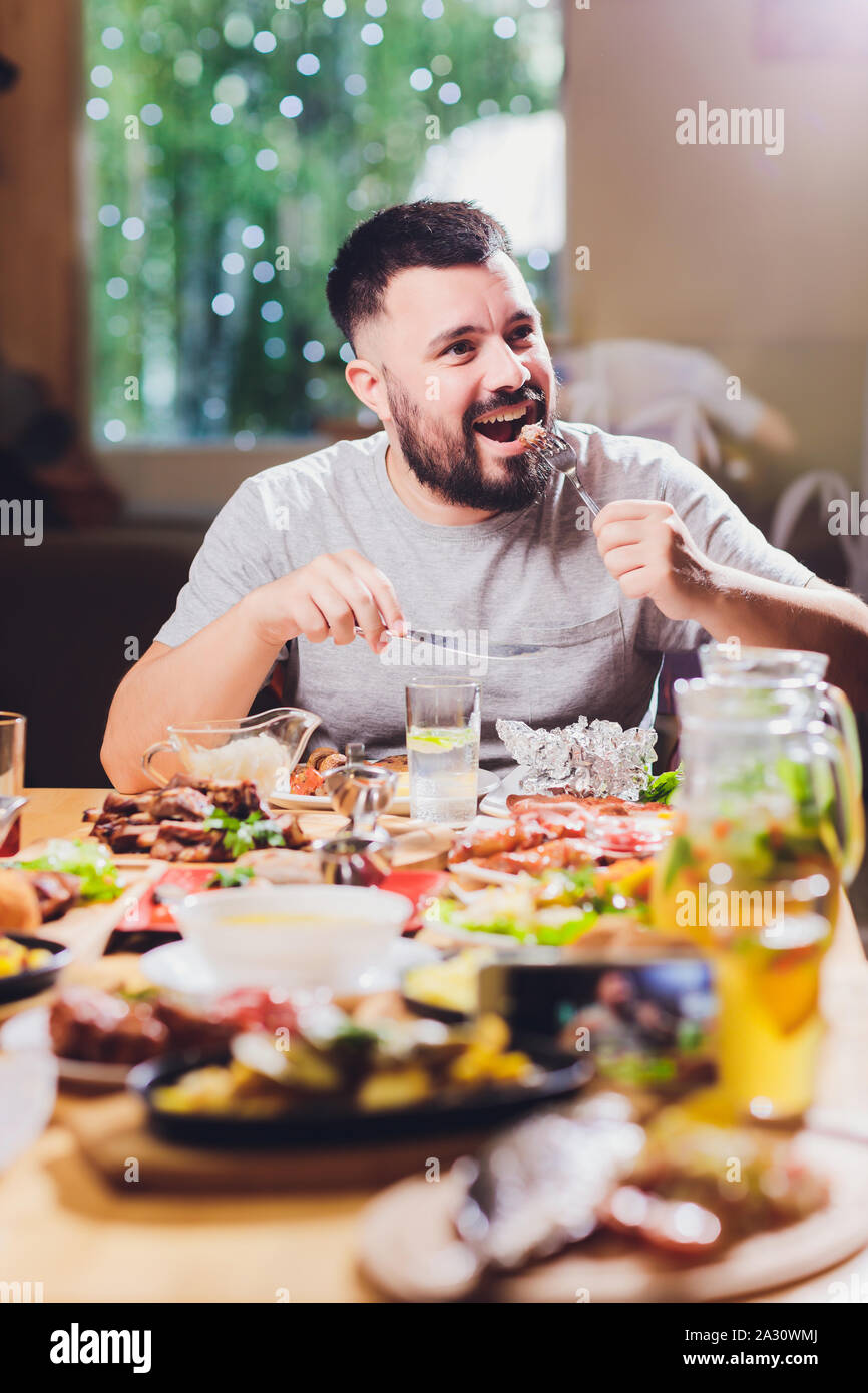 man at the big table with food Stock Photo - Alamy