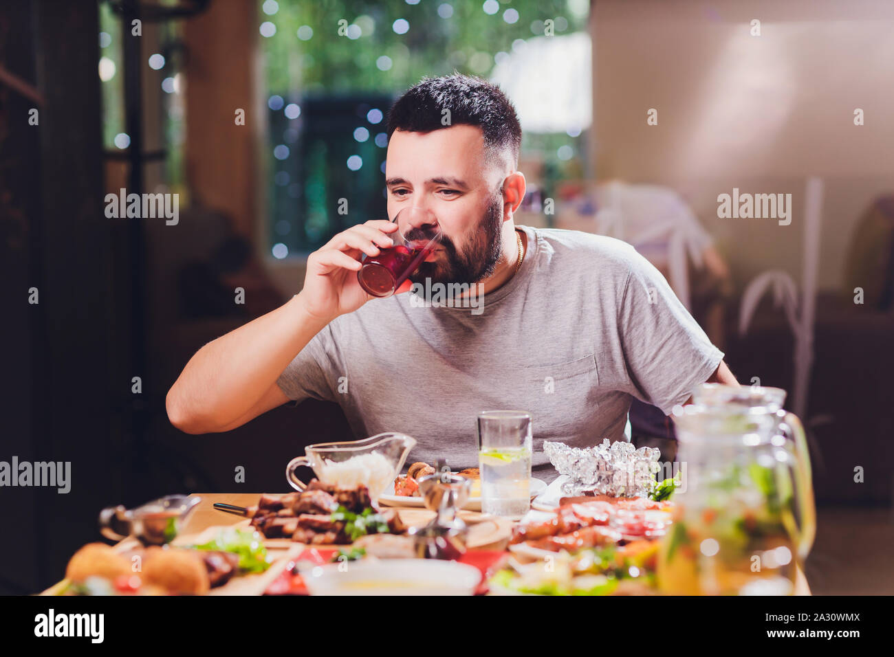 man at the big table with food Stock Photo - Alamy
