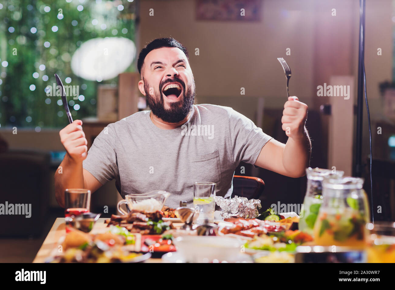 man at the big table with food Stock Photo - Alamy