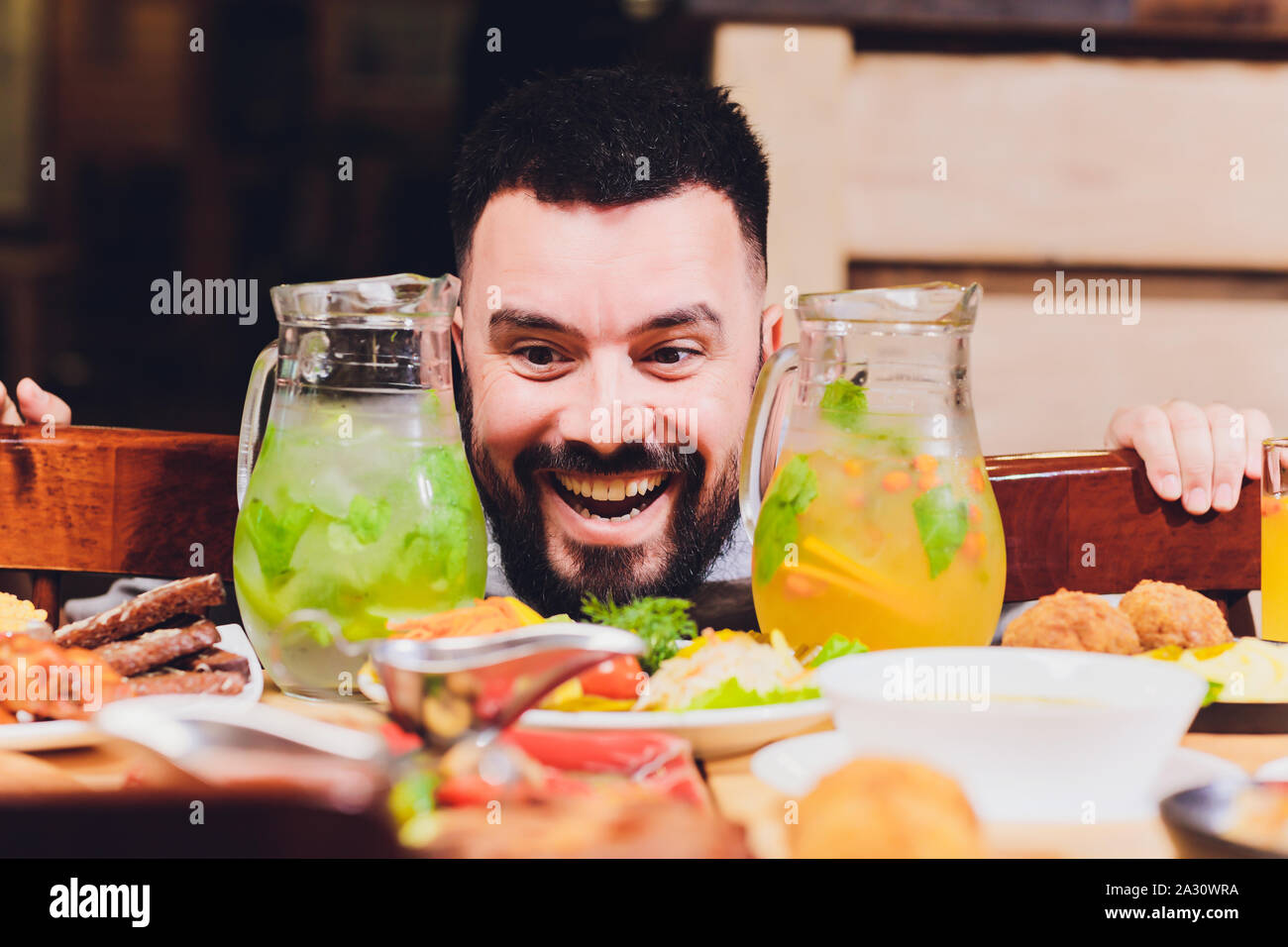 man at the big table with food Stock Photo - Alamy