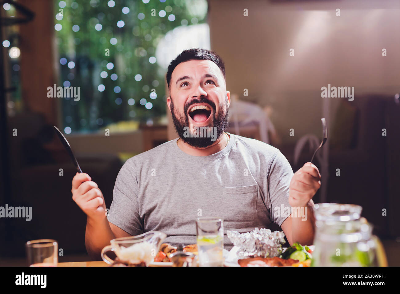 man at the big table with food Stock Photo - Alamy