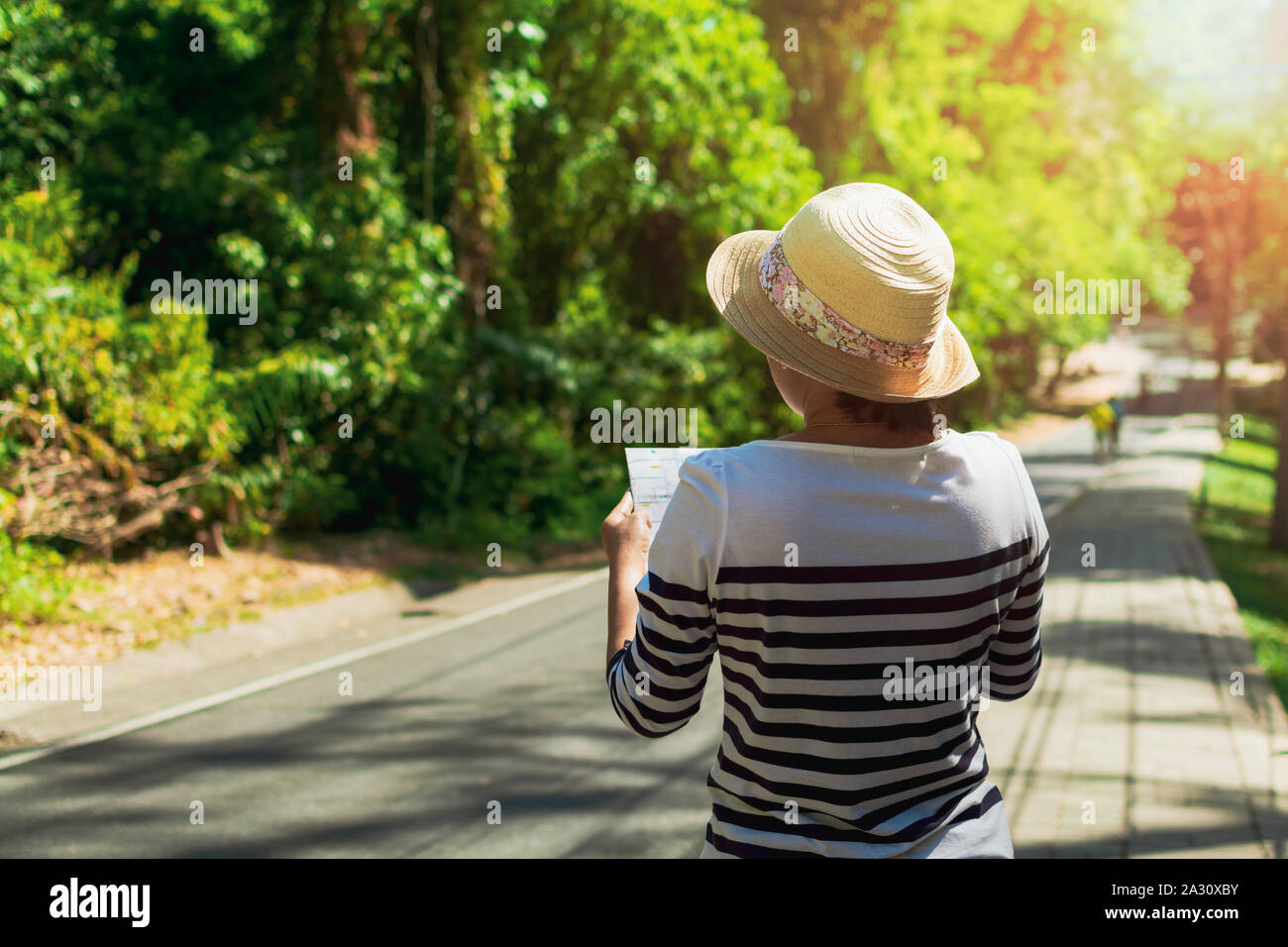 Woman traveler is viewing the map for traveling in rural area, Travel ...