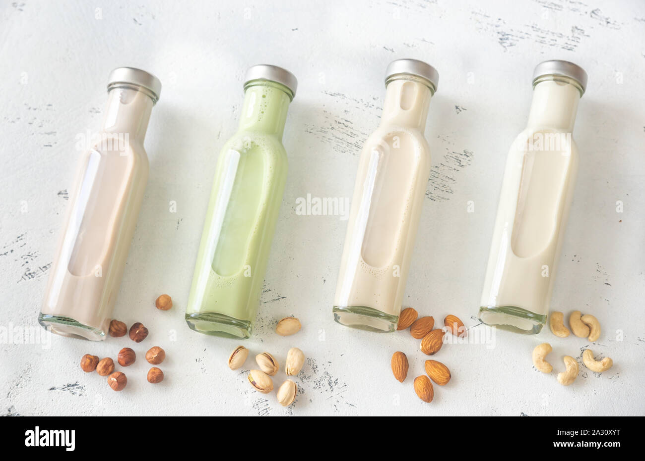 Assortment of different kinds of nut milk: top view Stock Photo - Alamy
