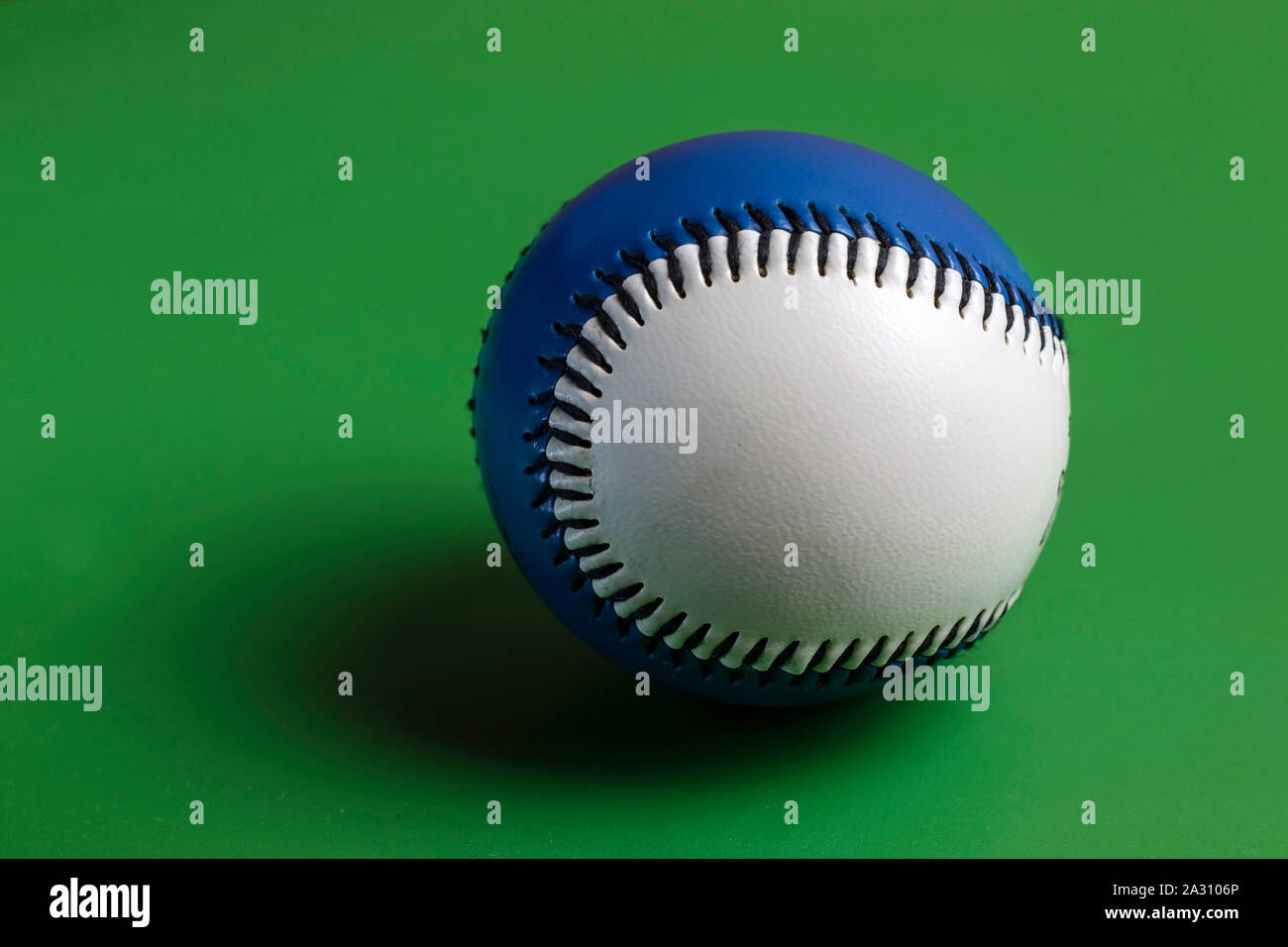 Baseball ball isolated on green background Stock Photo - Alamy