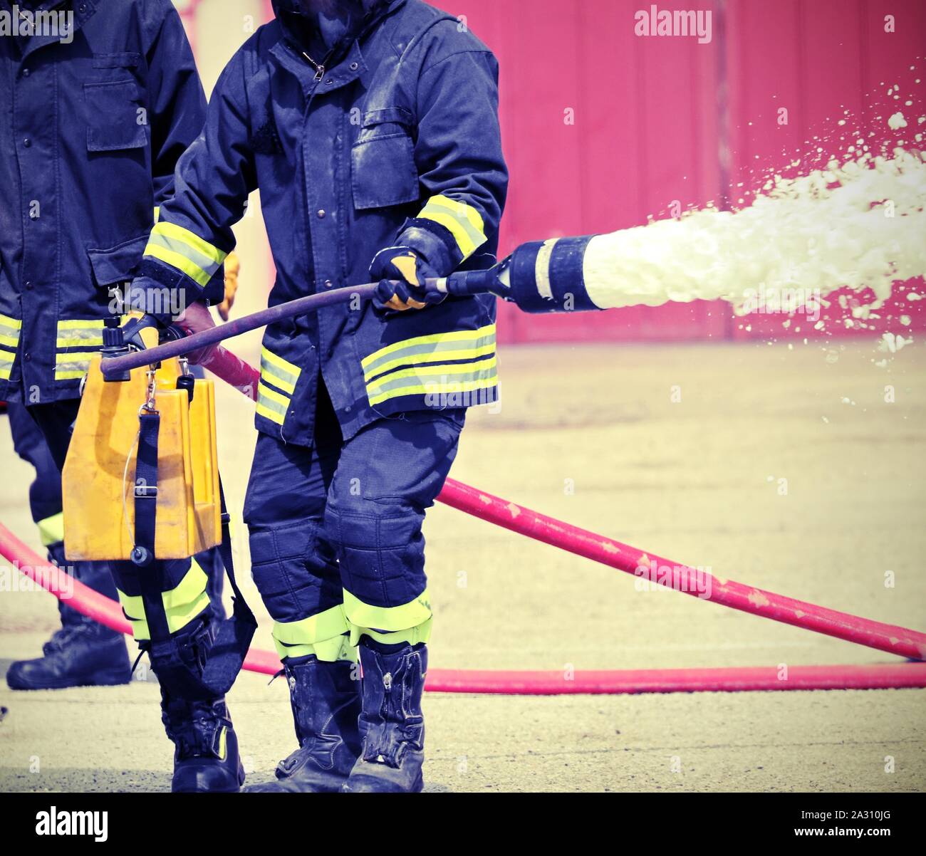 fireman sprays foam from a pump on a fire to extinguish it Stock Photo ...