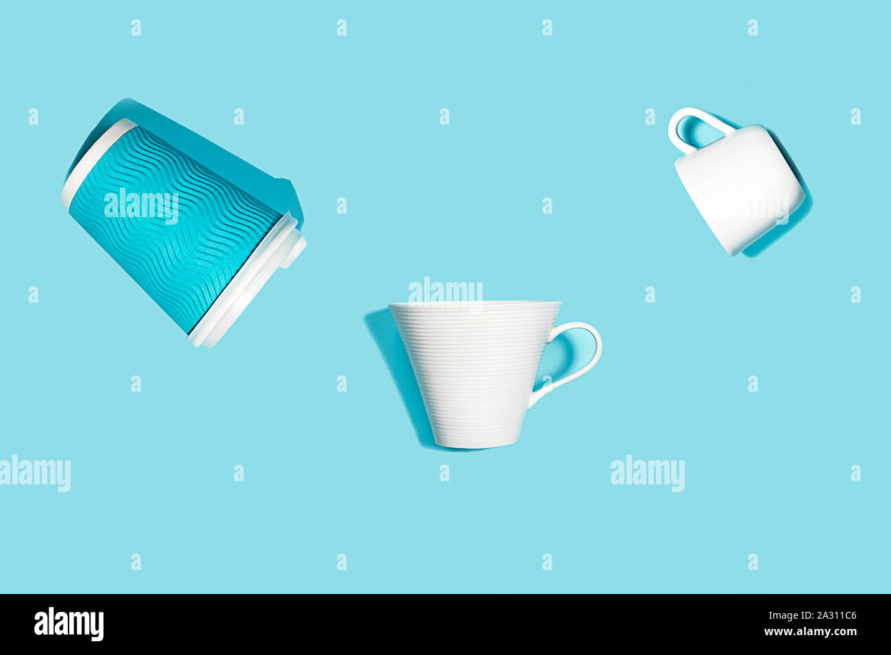 Coffee pattern of white ceramic and blue paper cup for coffee on bright ...