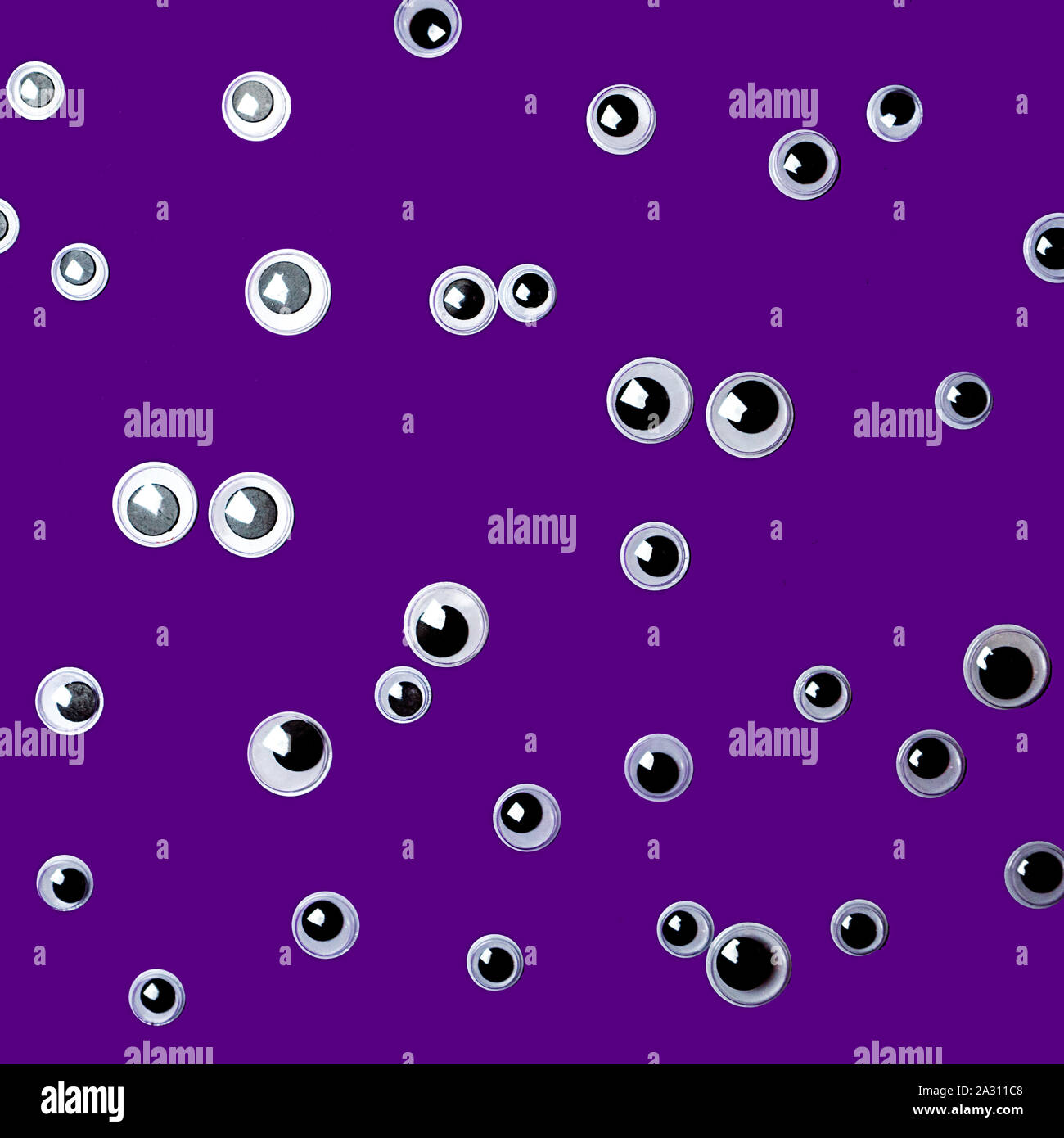 Funny Halloween concept for horror with eyes on dark purple color ...