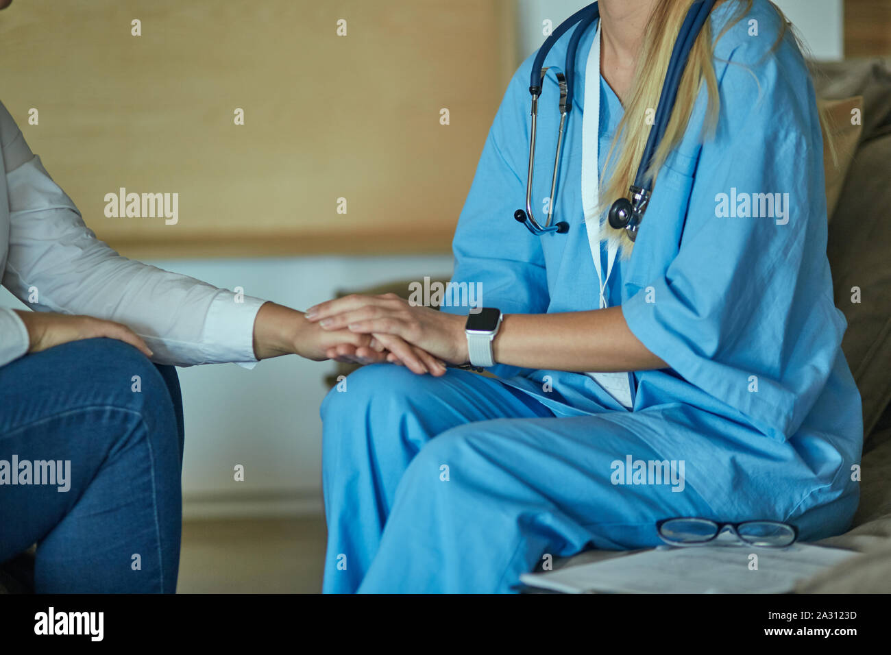 Hand of doctor reassuring her female patient Stock Photo - Alamy