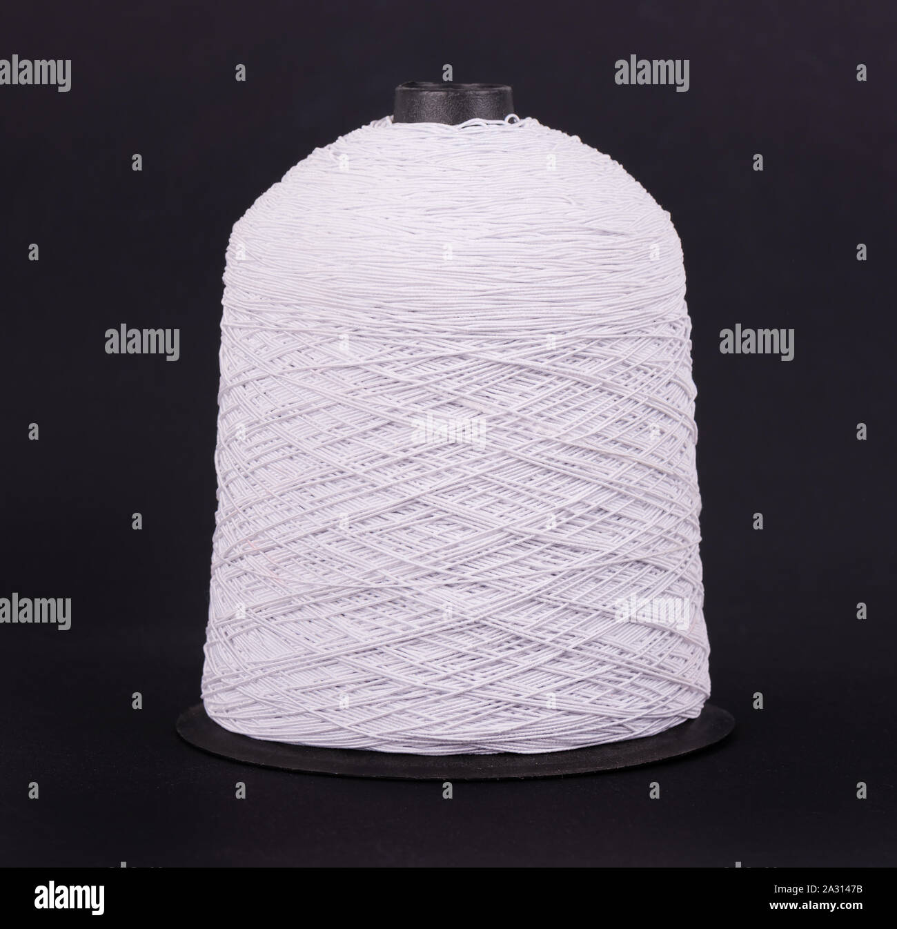 Sewing thread on black background. White thread for sewing garments ...