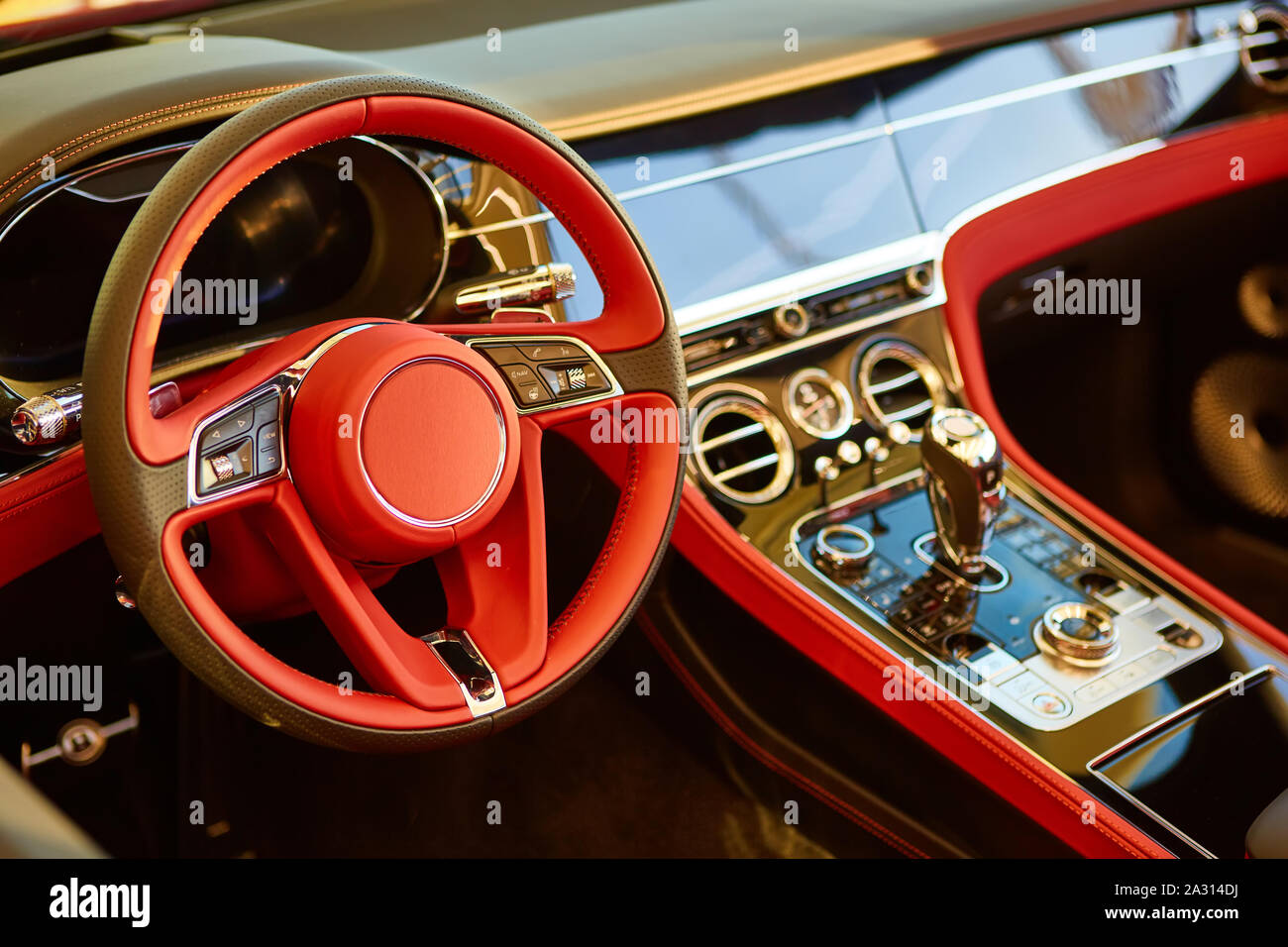 Red luxury car Interior. Steering wheel, shift lever and dashboard ...