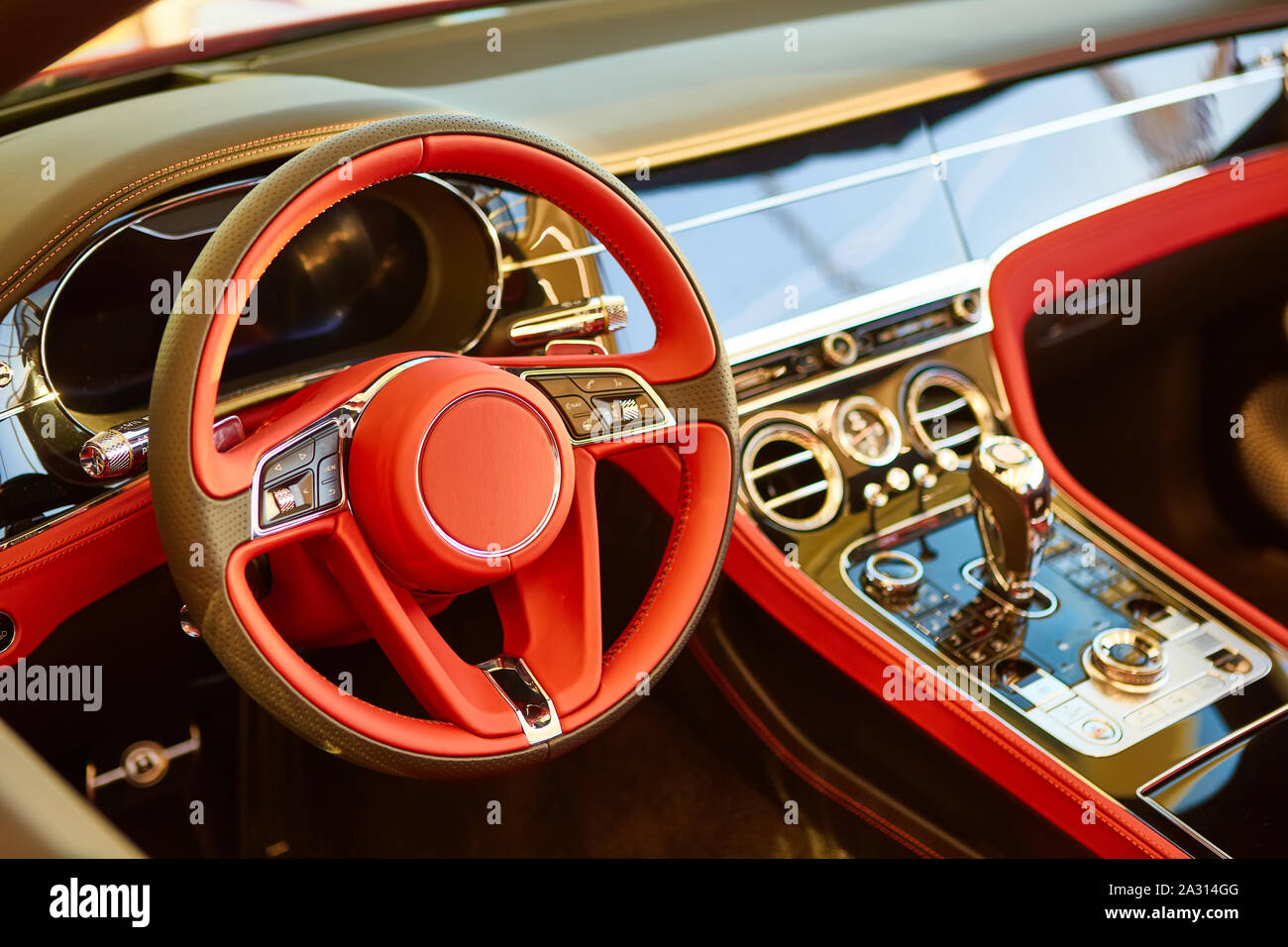 Red luxury car Interior. Steering wheel, shift lever and dashboard ...