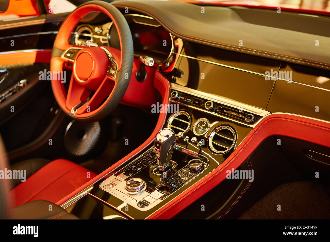 Red luxury car Interior. Steering wheel, shift lever and dashboard ...